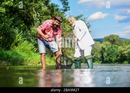 Best weekend ever. Two male friends fishing together. Catching and fishing concept. happy ...