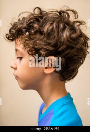 Cute school age kid side view portrait on a natural light Stock Photo ...
