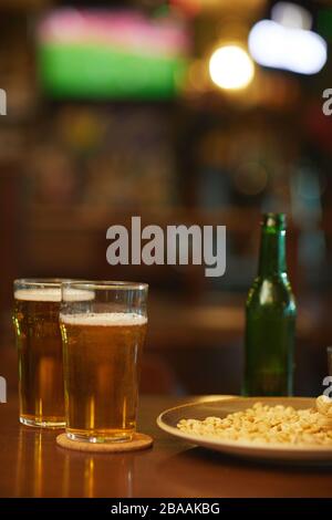 Two bottle of beer on counter in pub. Alcoholic beverage over pub ...