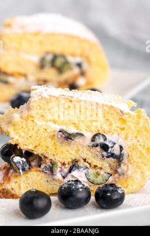 Blueberry roulade with icing sugar Stock Photo - Alamy