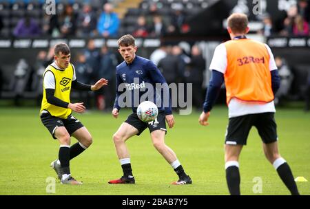 Derby County's Max Bird (centre) battle for the ball with Oxford United ...