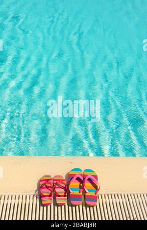 Colorful striped flip flops at swimming pool Stock Photo - Alamy