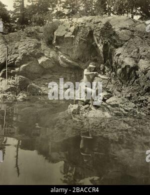 man hunting fish with bow and arrow attached to string Stock Photo - Alamy