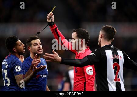 Referee Chris Kavanagh gives a yellow card to Carlos Alcaraz of Everton ...