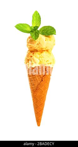 Two balls of mango ice cream and slices of fresh mango on a gray ...