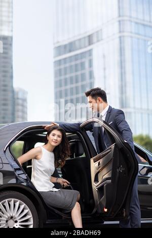 Confident Chinese businesswoman getting out of car Stock Photo - Alamy