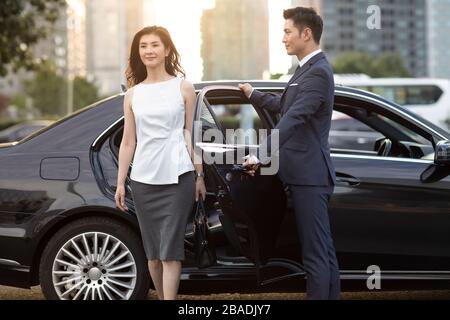 Confident Chinese businesswoman getting out of car Stock Photo - Alamy