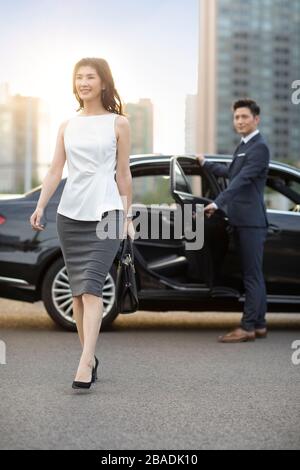 Confident Chinese businesswoman getting out of car Stock Photo - Alamy
