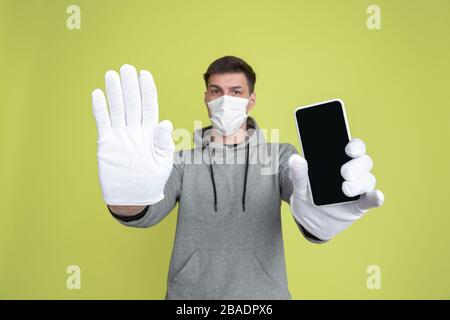 Showing phone's blank screen. Caucasian man's portrait isolated on ...