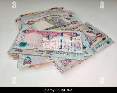 Five bundles of one thousand United Arab Emirates Dirhams, in glass box ...