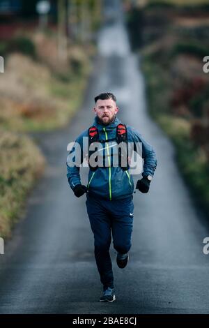 Man running on road, Glasgow, Scotland Stock Photo - Alamy