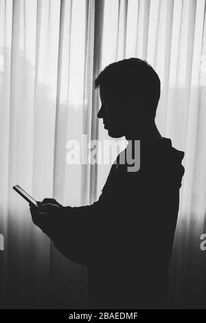 teenager boy with mobile phone at home wall isolated Stock Photo - Alamy