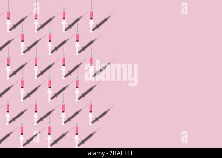 Beautiful creative pattern syringe medical on a pink background ...