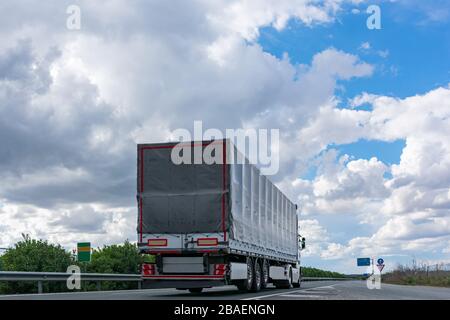 Truck with canvas semi-trailer with side opening for general transport ...