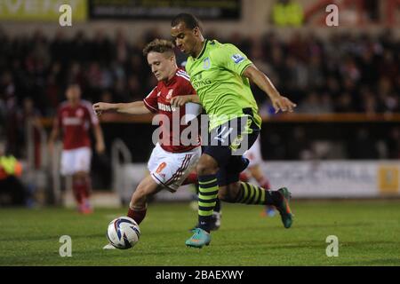Swindon Town's Simon Ferry (left) and Joe Devera (right) battle for the ...