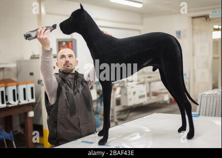 Technician doing post production, finishing and processing of the large ...