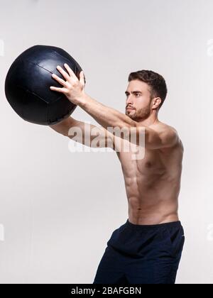 Handsome athlete in good shape preparing the barbell for training ...