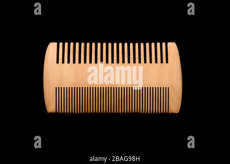 Wooden beard comb isolated on black backgrounds Stock Photo - Alamy