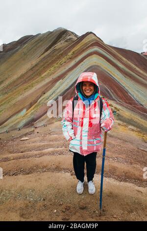 Woman standing on the mountain of the Peruvian Andes with the entire ...