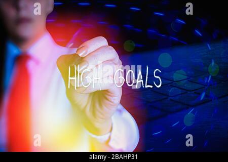 Writing note showing High Goals. Business concept for object of a ...
