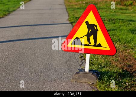 A sign of a man with a shovel. Caution, road works are under way Stock ...