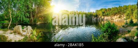 A beautiful shot of a lake surrounded by green mountains under the ...
