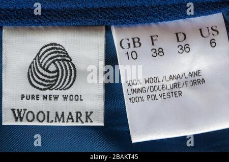 Woolmark pure new wool symbol on label in woman's blue suit clothing ...