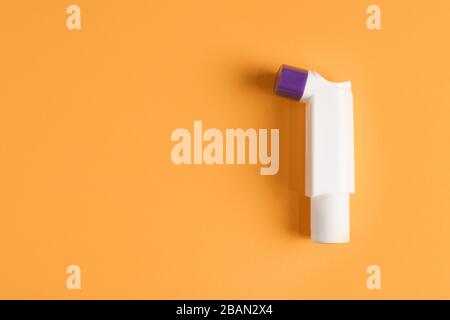 ASTHMA INHALER ON YELLOW BACKGROUND Stock Photo - Alamy