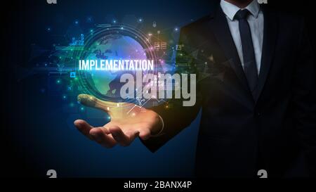 Elegant hand holding IMPLEMENTATION inscription, digital technology ...