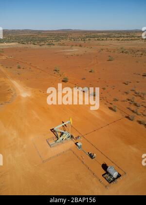 Aerial of a donkey pumping oil from underground reserves on the ...