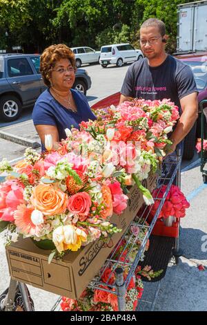 African american woman florist using laptop at florist Stock Photo - Alamy