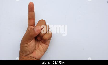 Left hand photographed with the meaning of a symbol and white ...