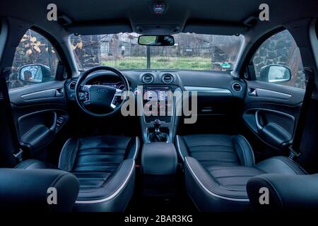 Beautiful interior view of electric car BMW iX40 on road. Woman driver ...