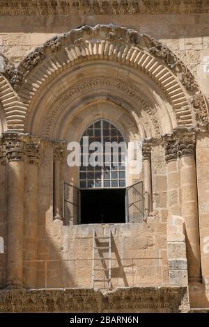 The immovable ladder which leans against a window ledge in the upper ...