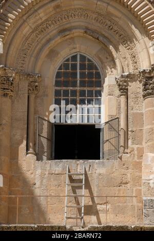 The immovable ladder which leans against a window ledge in the upper ...