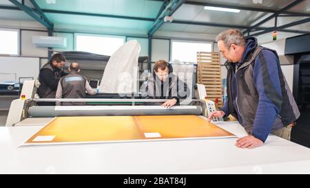 Large group of worker printmaker technician operator works in digital ...