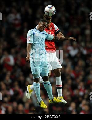 Coventry City's Franck Moussa (left) and Arsenal's Martin Angha battle ...