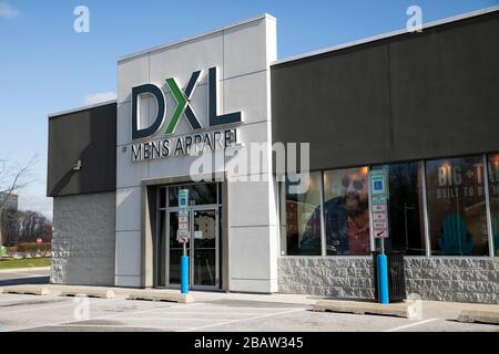 A logo sign outside of a Destination XL (DXL) retail store location in ...