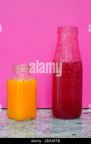 Glass bottles filled with colorful homemade beet smoothies Stock Photo ...