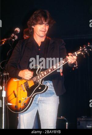 John Prine sings and plays guitar onstage at the Bottom Line, in July ...