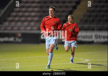 Coventry City's Stuart Urquhart (left) warms up with team-mates before ...