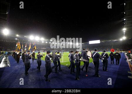 An Armed forces band performs as it marches around the pitch at half ...