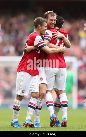 Arsenal's Per Mertesacker (centre) celebrates scoring his side's first ...