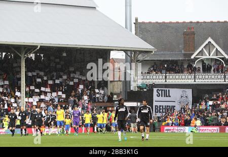 Fulham and Arsenal players walk out onto the pitch for the match Stock ...