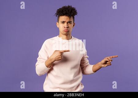 Portrait of gloomy, pouting frowning hipster guy dont have something he ...