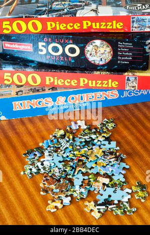 A selection of jigsaw boxes and pieces Stock Photo - Alamy
