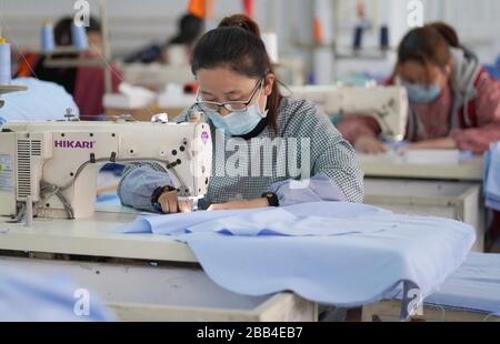People work in a poverty-alleviation factory in Jianhe county ...