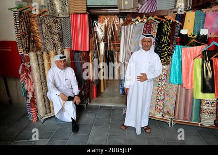Salesman outside a shop selling fabric in Doha, Qatar Stock Photo - Alamy