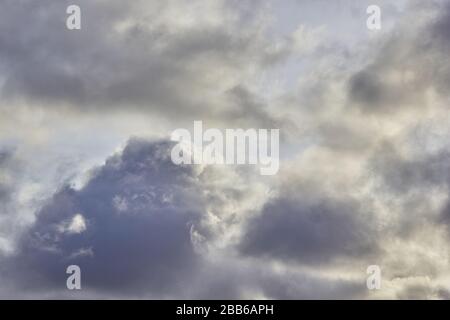 low-floating Cumulus clouds at dawn against a blue sky Stock Photo - Alamy