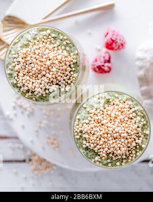 Two chia seed pudding with matcha green tea, kiwi and granola, orange ...